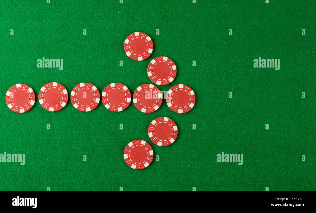 chips arrow pointing above green back ground Stock Photo - Alamy