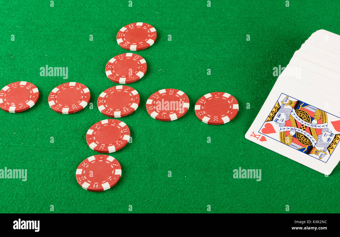 red poker chips over green background Stock Photo - Alamy