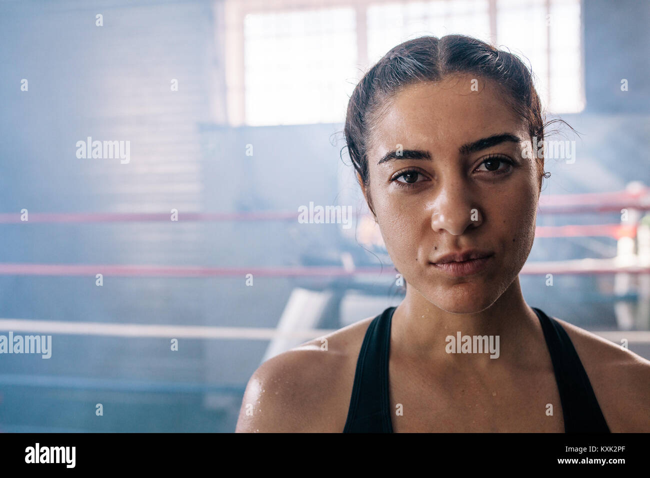 Close up of a female boxer inside a boxing ring. Woman boxer at a ...
