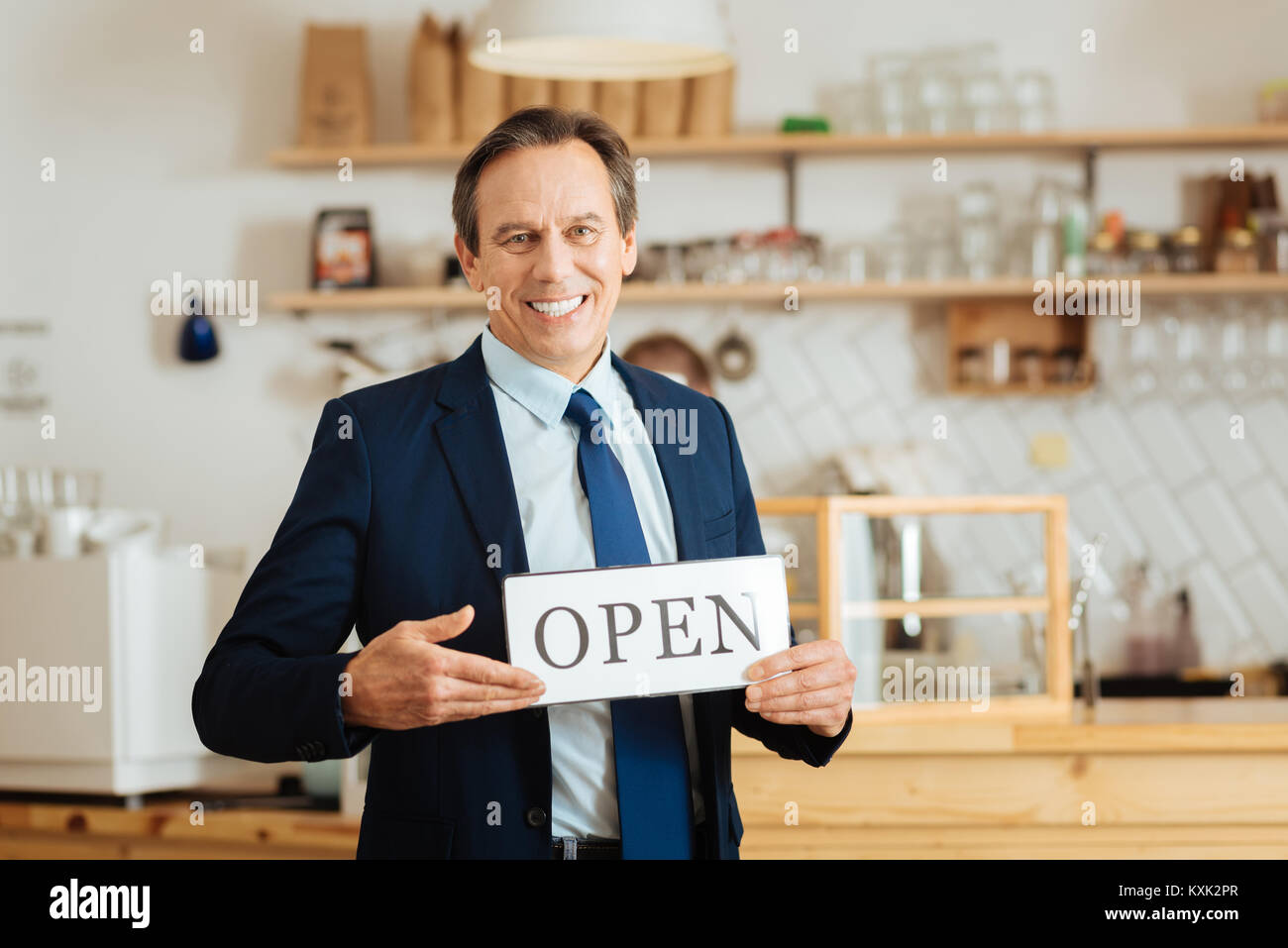 Joyful satisfied man smiling and showing the plate Stock Photo - Alamy