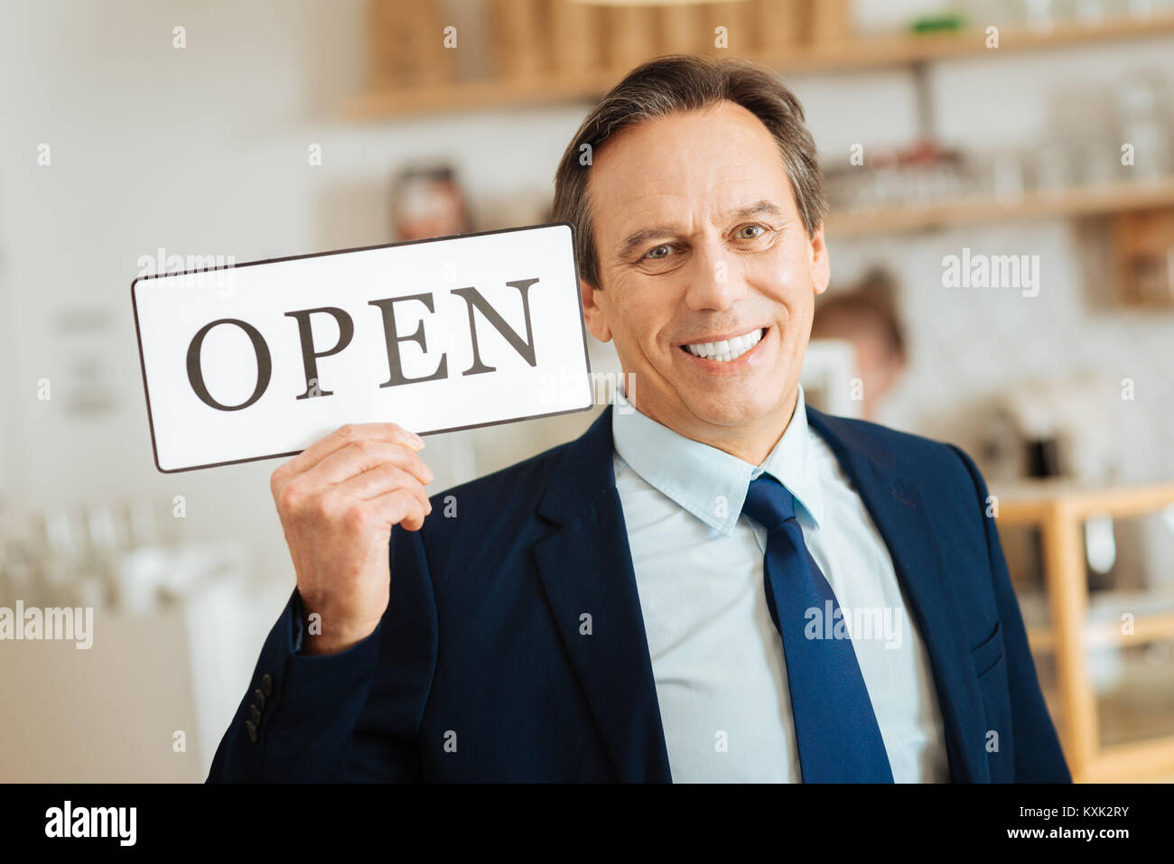 Satisfied pleasant man rejoicing and smiling Stock Photo - Alamy