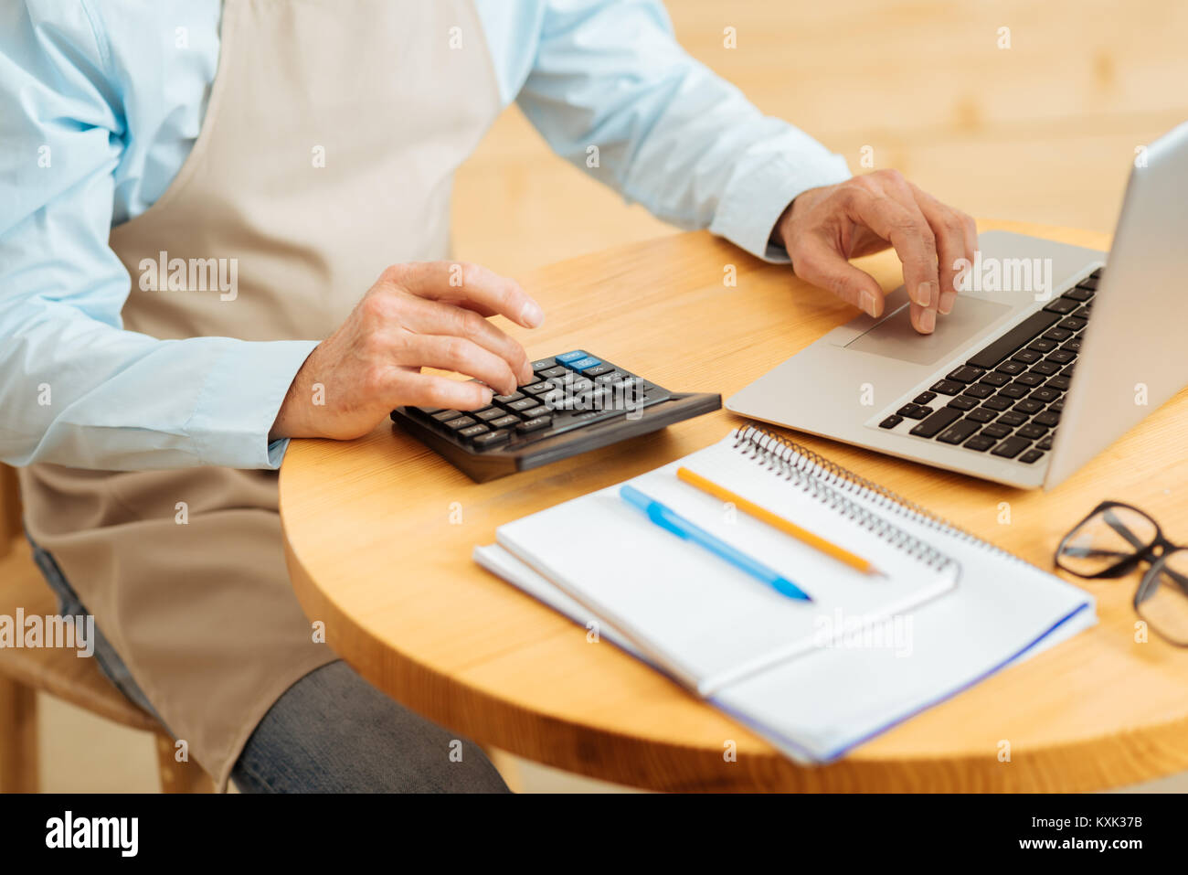 Senior busy man using the laptop and making calculation Stock Photo - Alamy