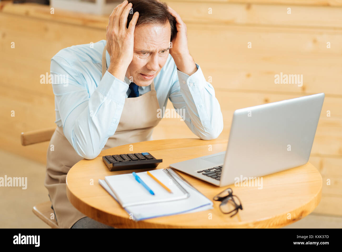 Sad disappointed entrepreneur sitting and looking at the screen Stock ...