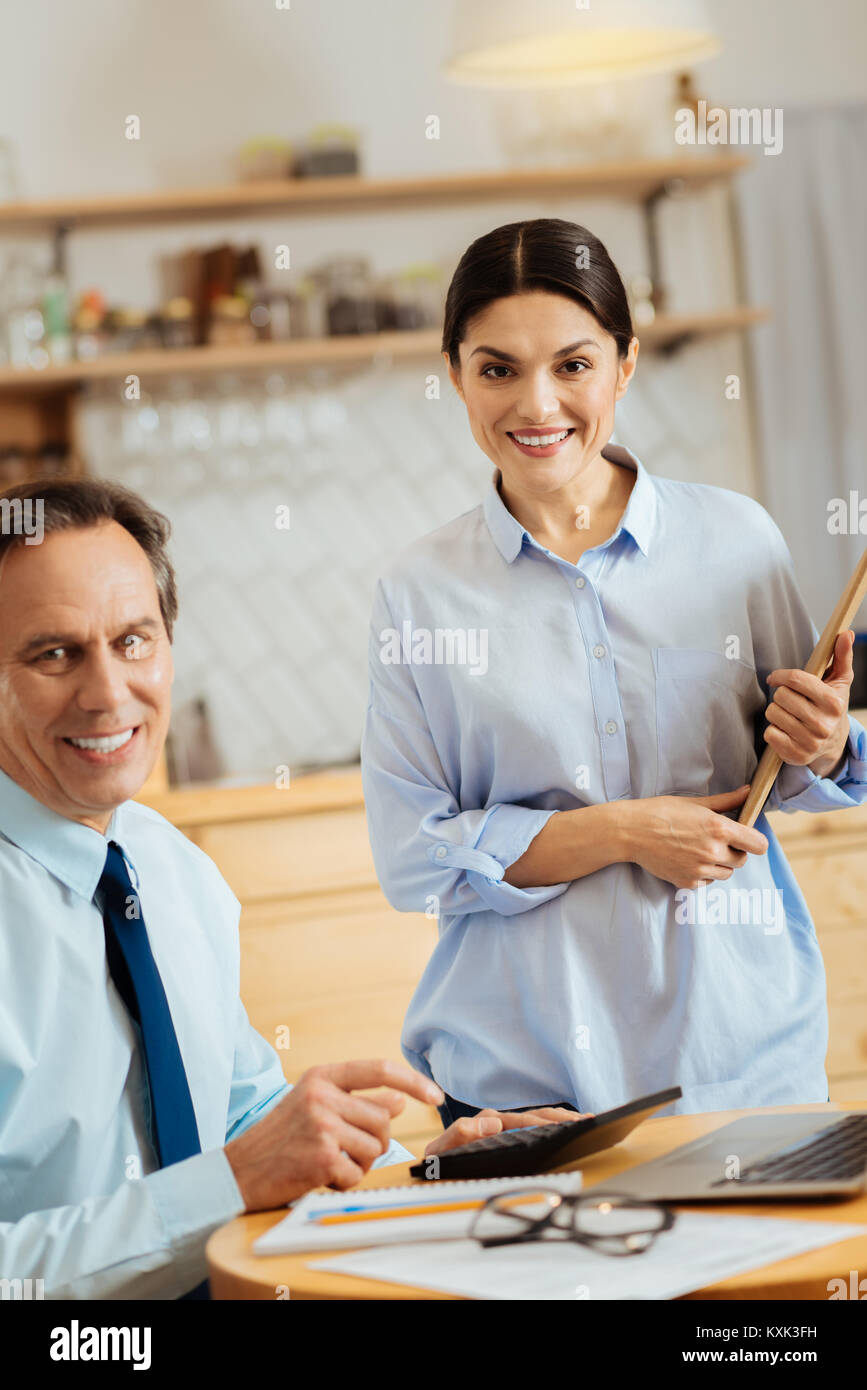 Joyful friendly colleagues working together and looking straight Stock ...