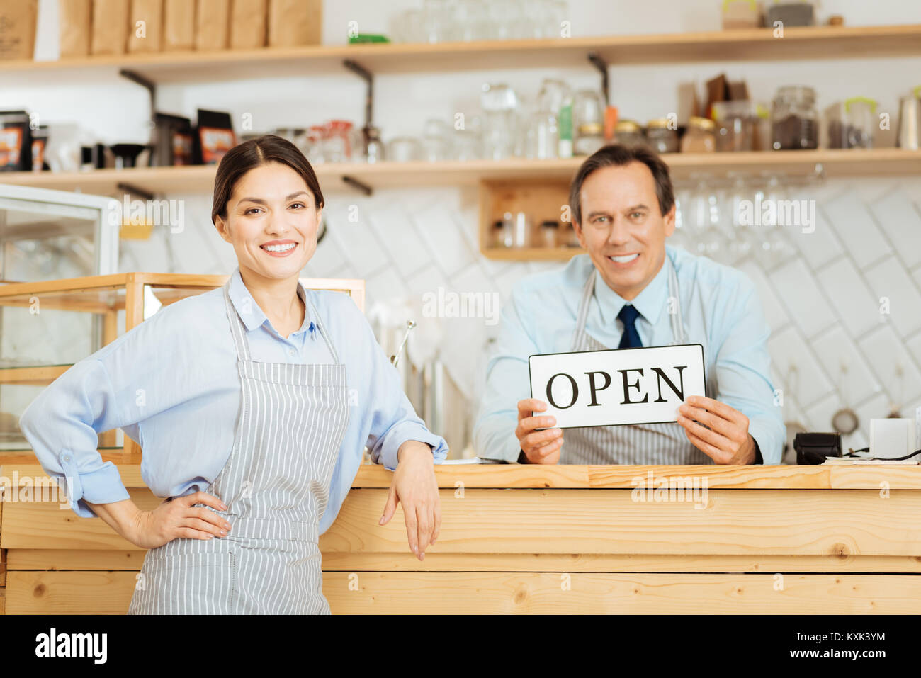 Pleasant friendly employees standing in the shop and smiling Stock ...