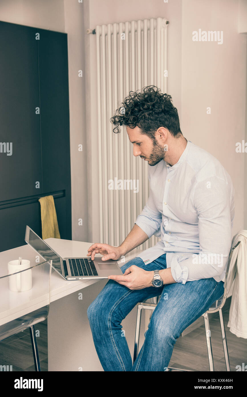 Handosme Man Working at Home at Computer Desk Stock Photo - Alamy