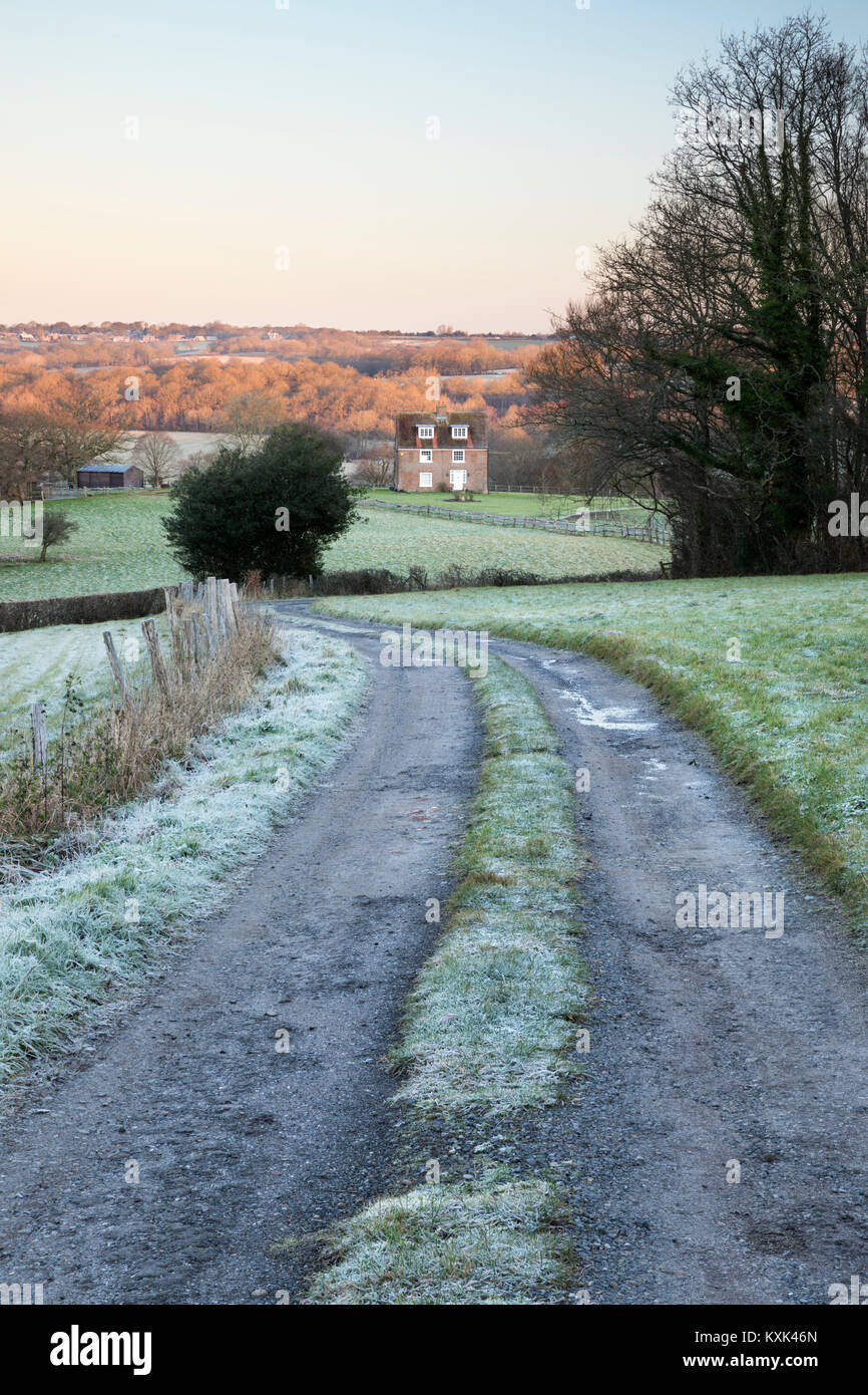 Farm track public footpath leading to farmhouse in winter frost, Ham ...