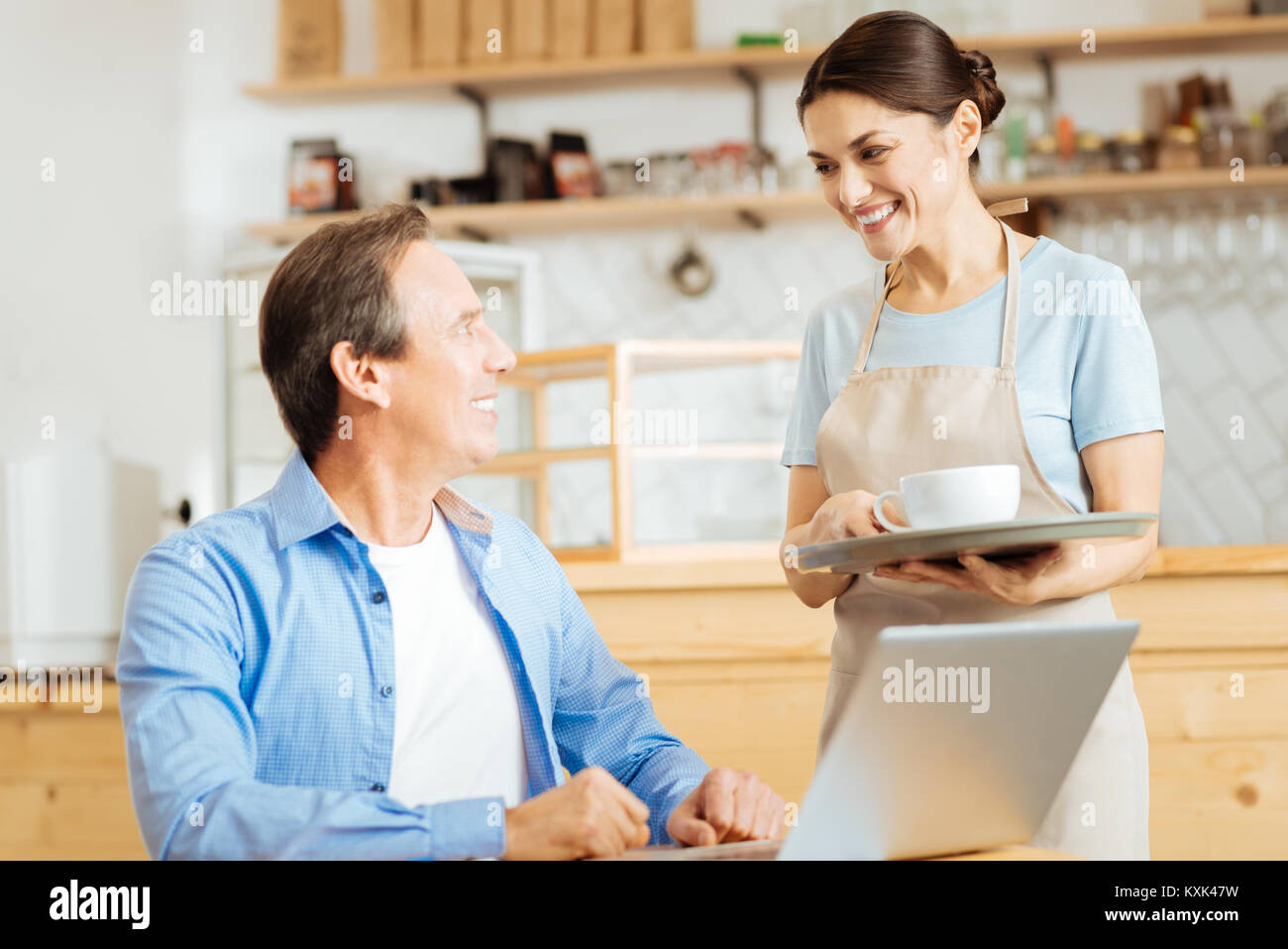 Polite cute waiter standing and holding the salver Stock Photo - Alamy