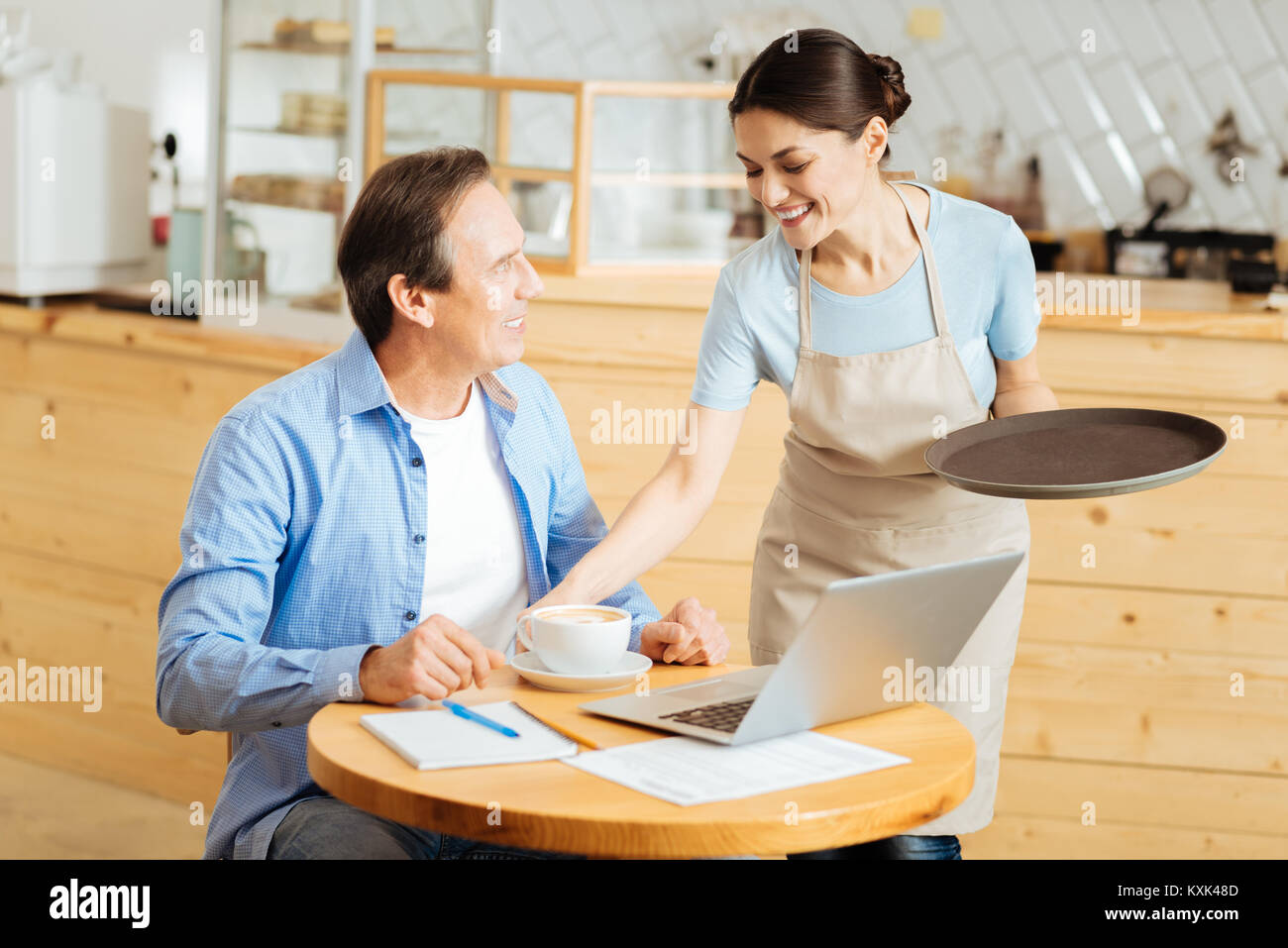 Smiling polite woman standing and giving the offer Stock Photo - Alamy