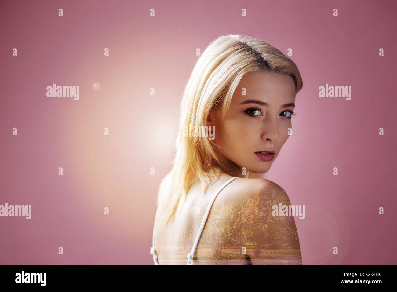 Attractive pleasant woman turning her head to you Stock Photo - Alamy