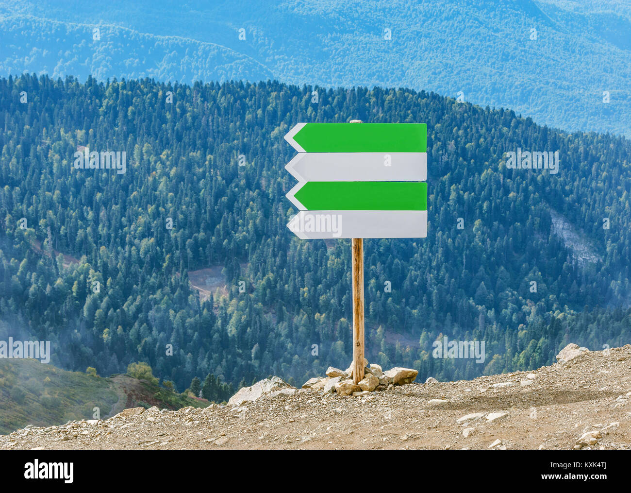 Sign arrows on the mountain landscape background Stock Photo - Alamy
