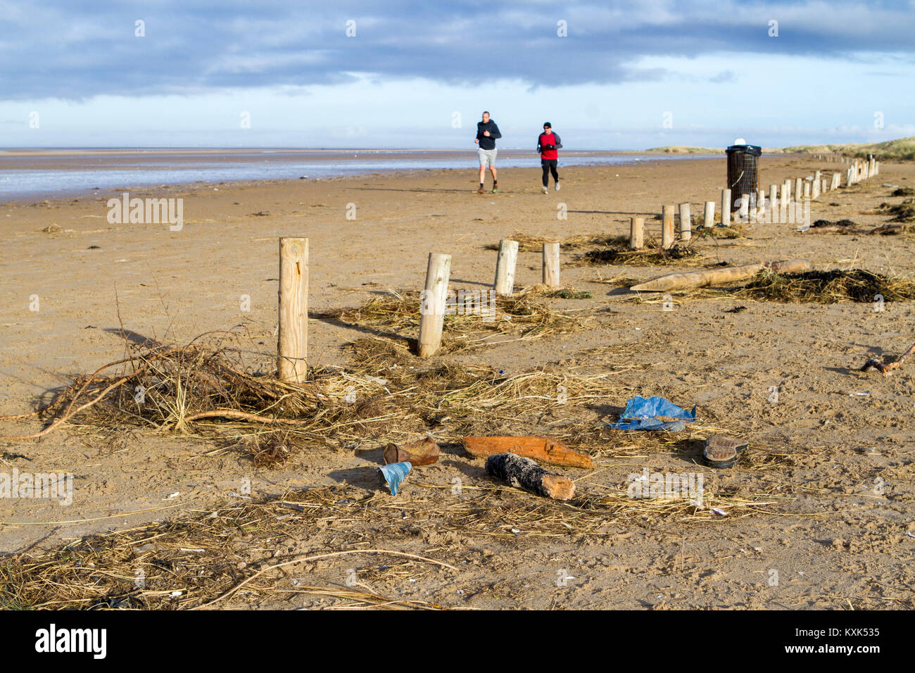 Plastic bottles and waste beach debris washed up on shore on the beach ...