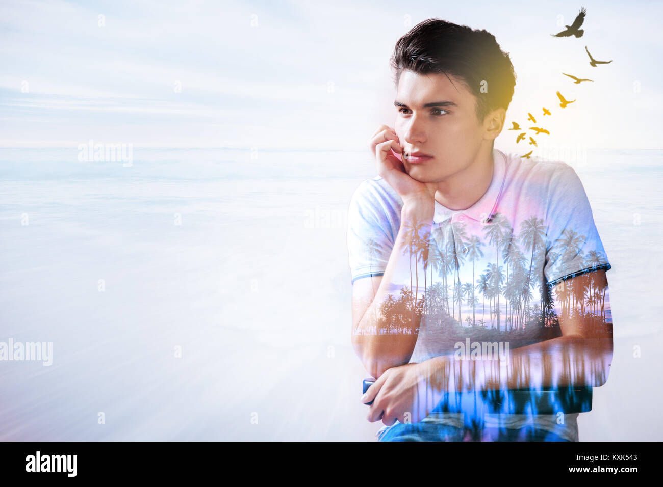 Handsome thoughtful man imagining palm trees Stock Photo - Alamy