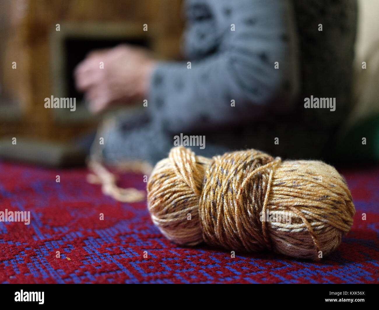Old woman knitting some clothing from wool threads Stock Photo - Alamy