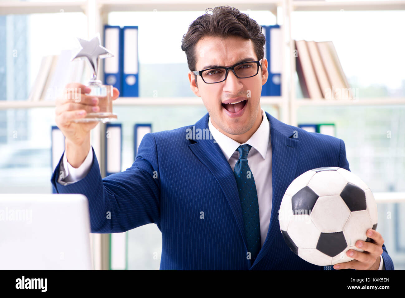 Businessman playing football in the office Stock Photo - Alamy