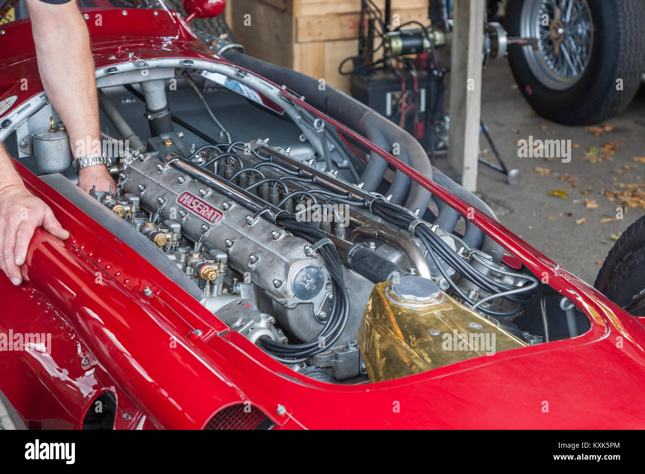 A mechanic tuning a1954 Maserati 250F at the Goodwood Revival 2016 ...