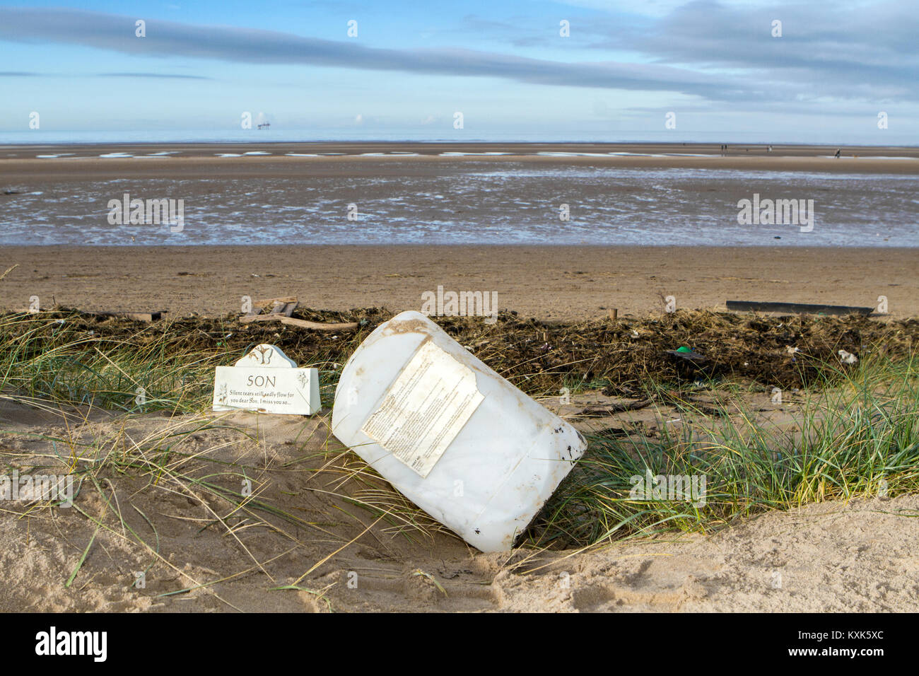 Plastic bottles and waste beach debris washed up on shore on the beach ...