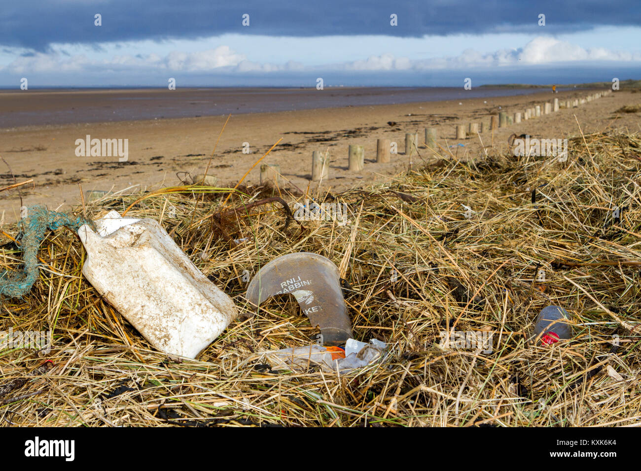 Plastic bottles and waste beach debris washed up on shore on the beach ...