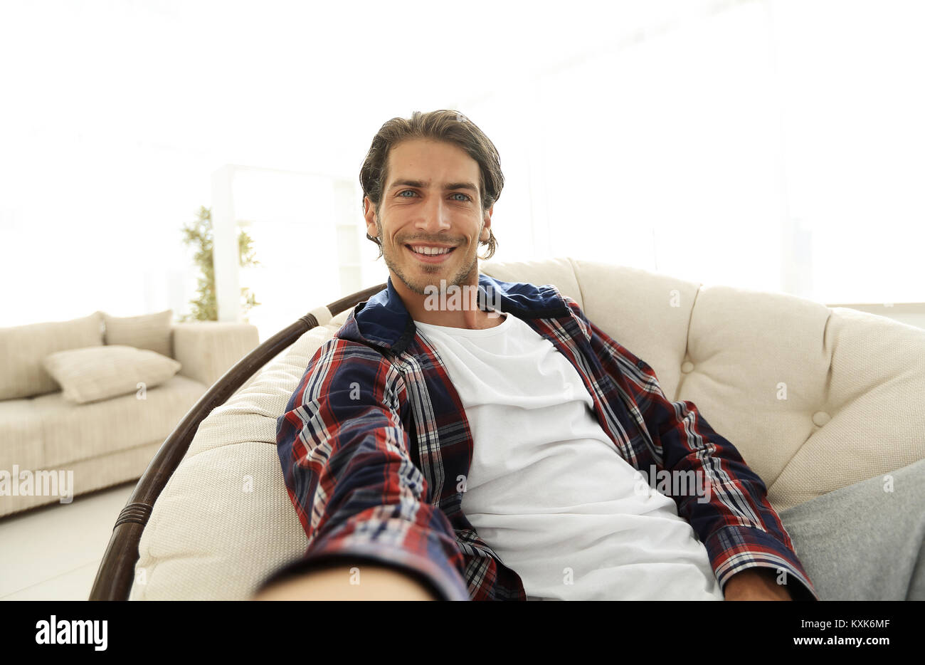 confident guy sitting in a chair and holding out his hand Stock Photo ...