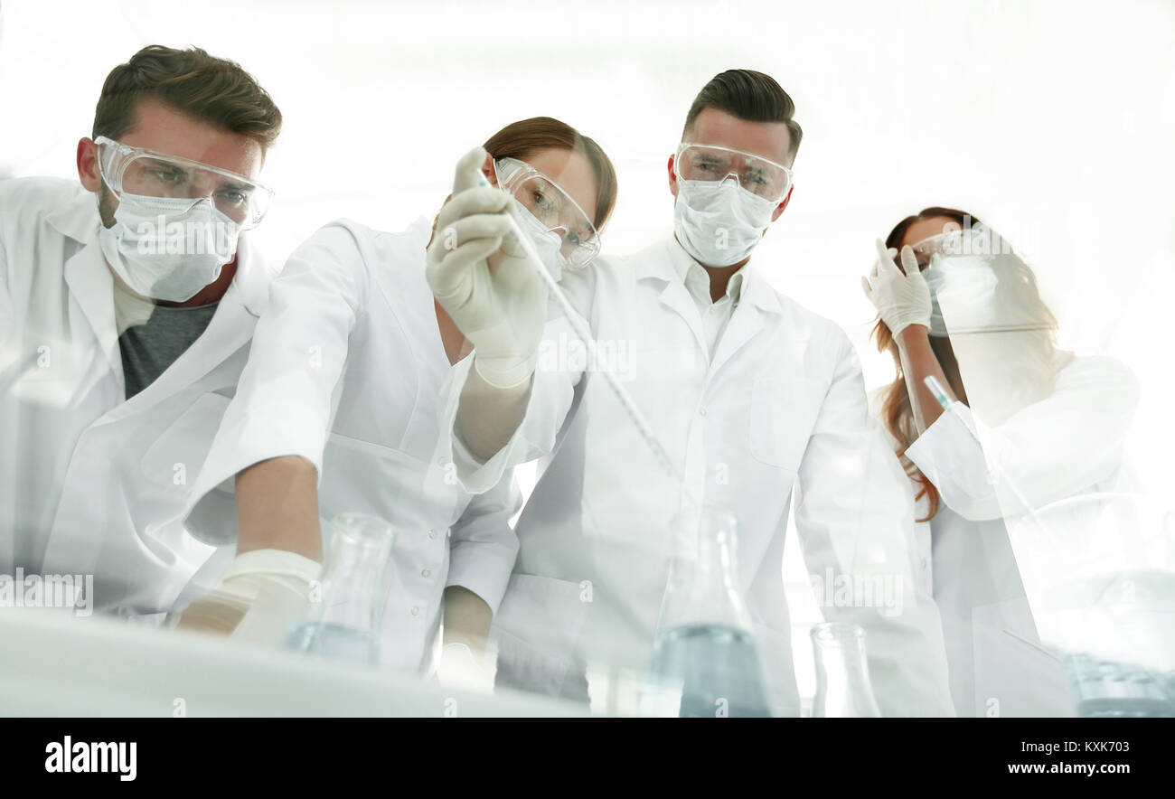 scientists working with test tubes and microscope in the laboratory ...