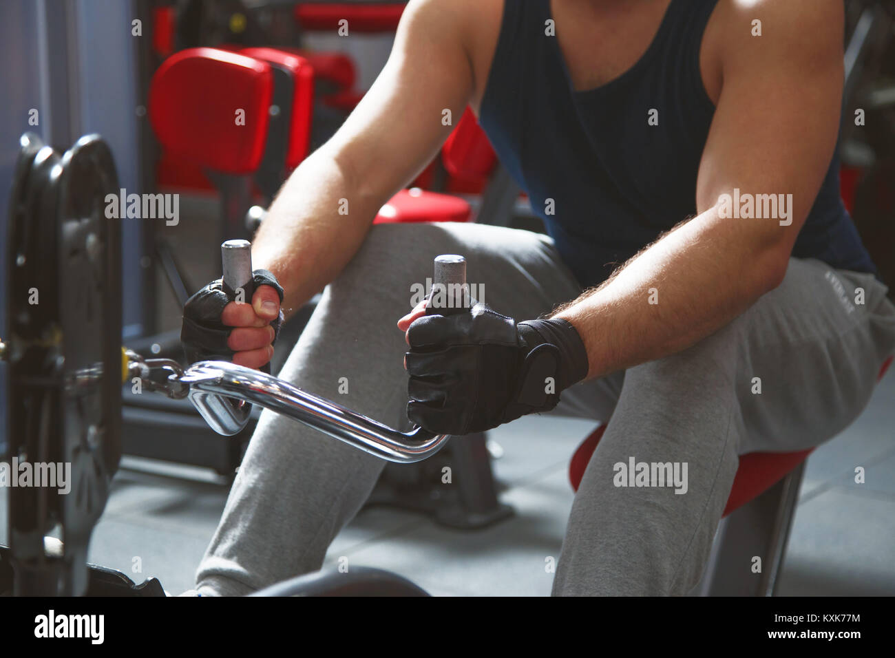 Rowing young man in gym training hands close up Stock Photo - Alamy