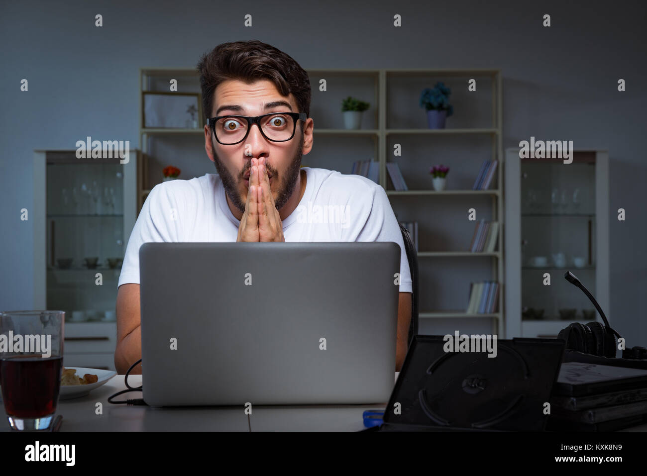 Young man staying late in office to do overtime work Stock Photo - Alamy