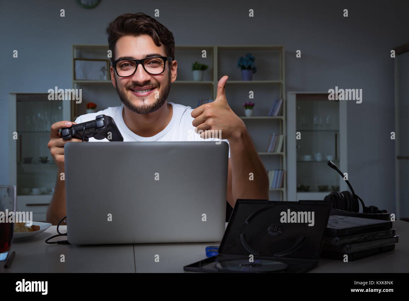 Young man playing games long hours late in the office Stock Photo - Alamy