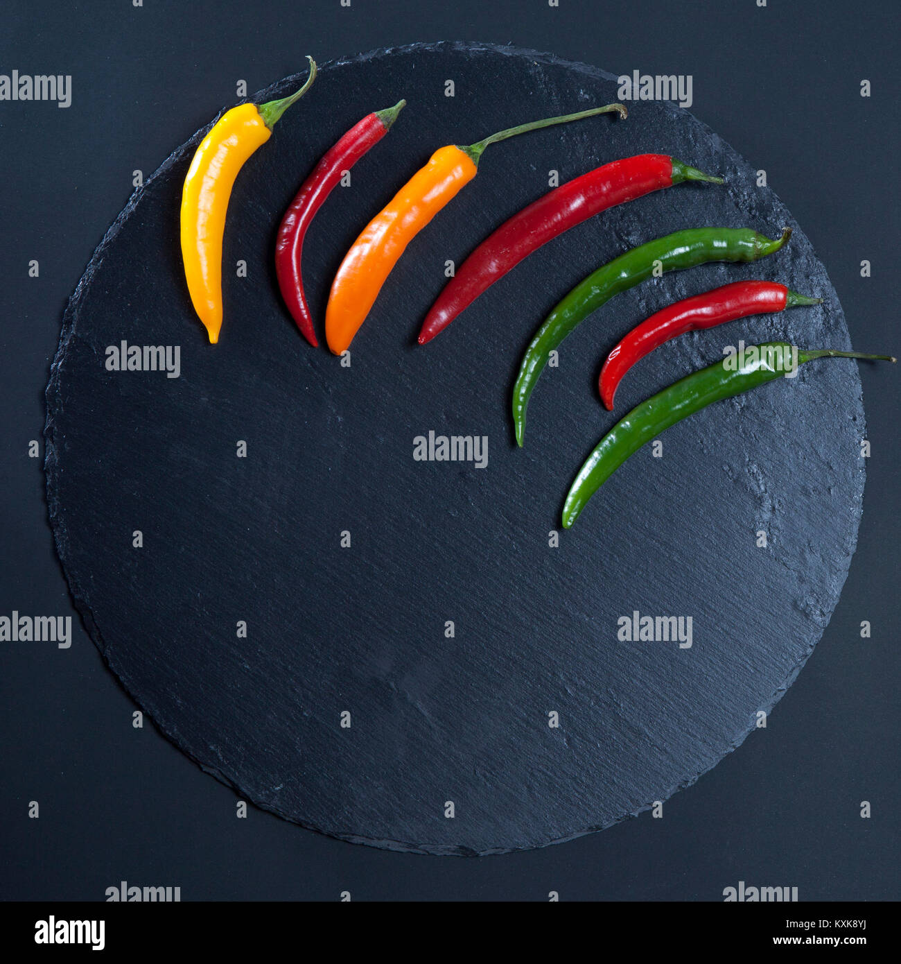 chilli pepper on black stone Stock Photo - Alamy