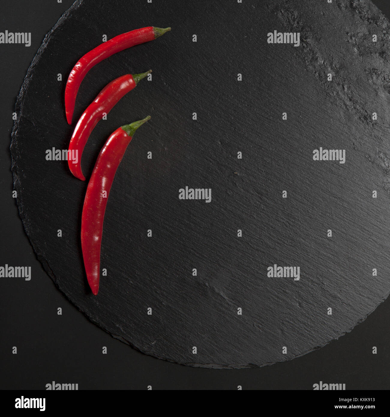 chilli pepper on black stone Stock Photo - Alamy