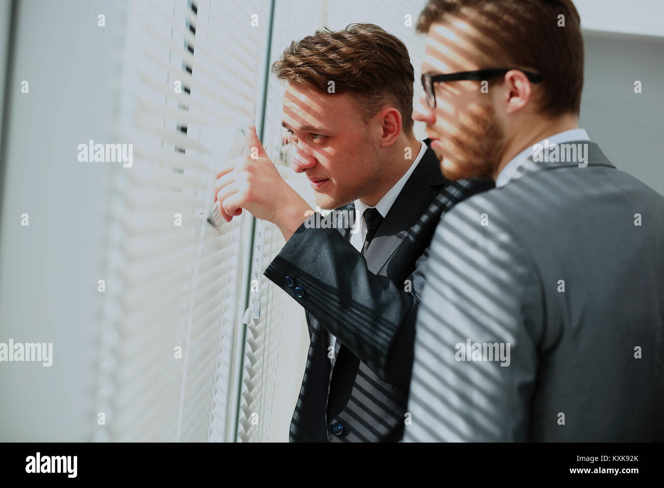 Business team looking through the office window, view from the back ...