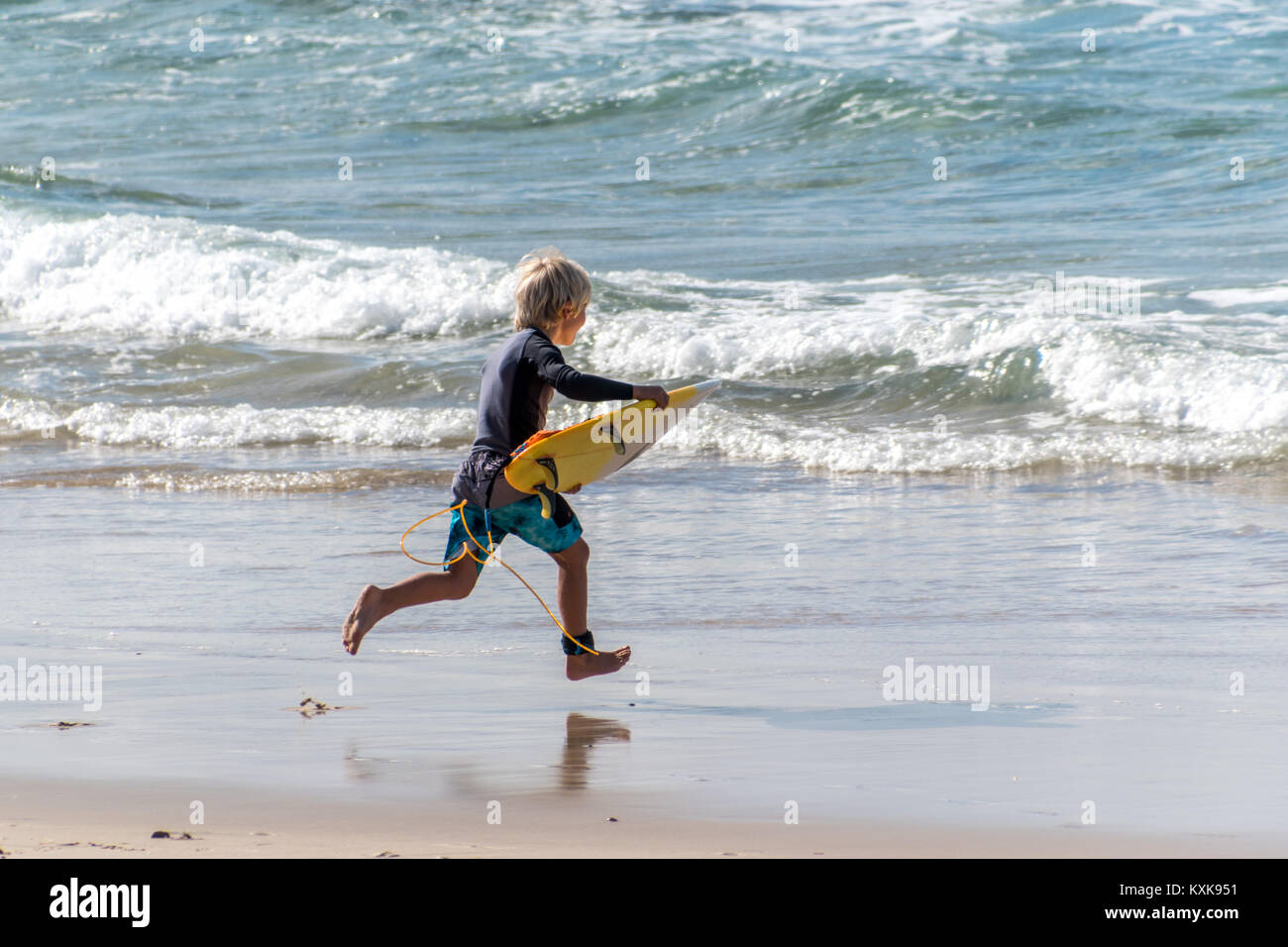 Surfer boy at the beach Stock Photo - Alamy
