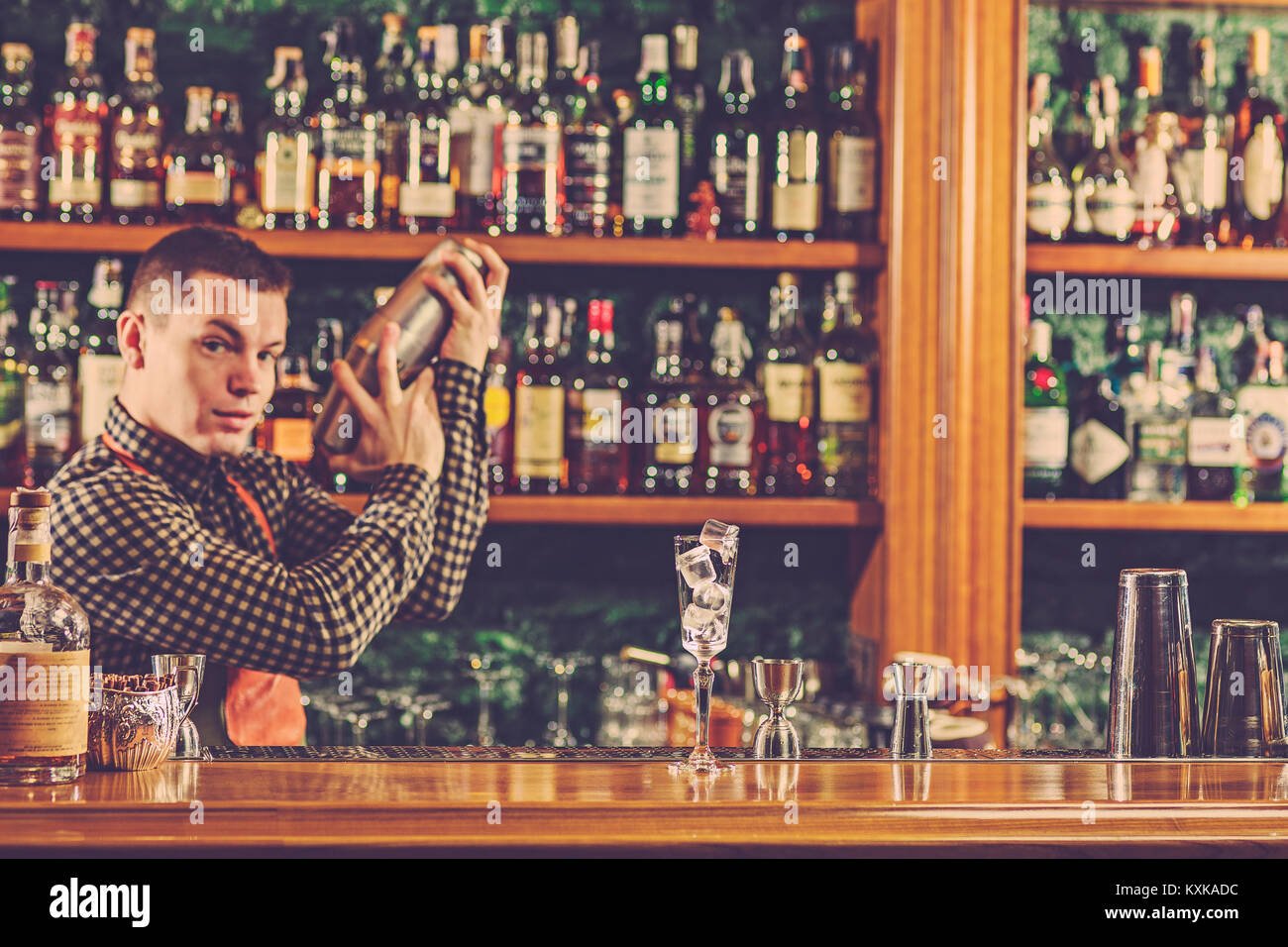 Barman making an alcoholic cocktail at the bar counter on the bar ...