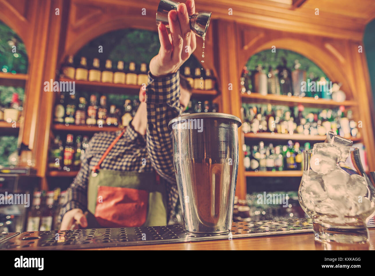 Barman making an alcoholic cocktail at the bar counter on the bar ...