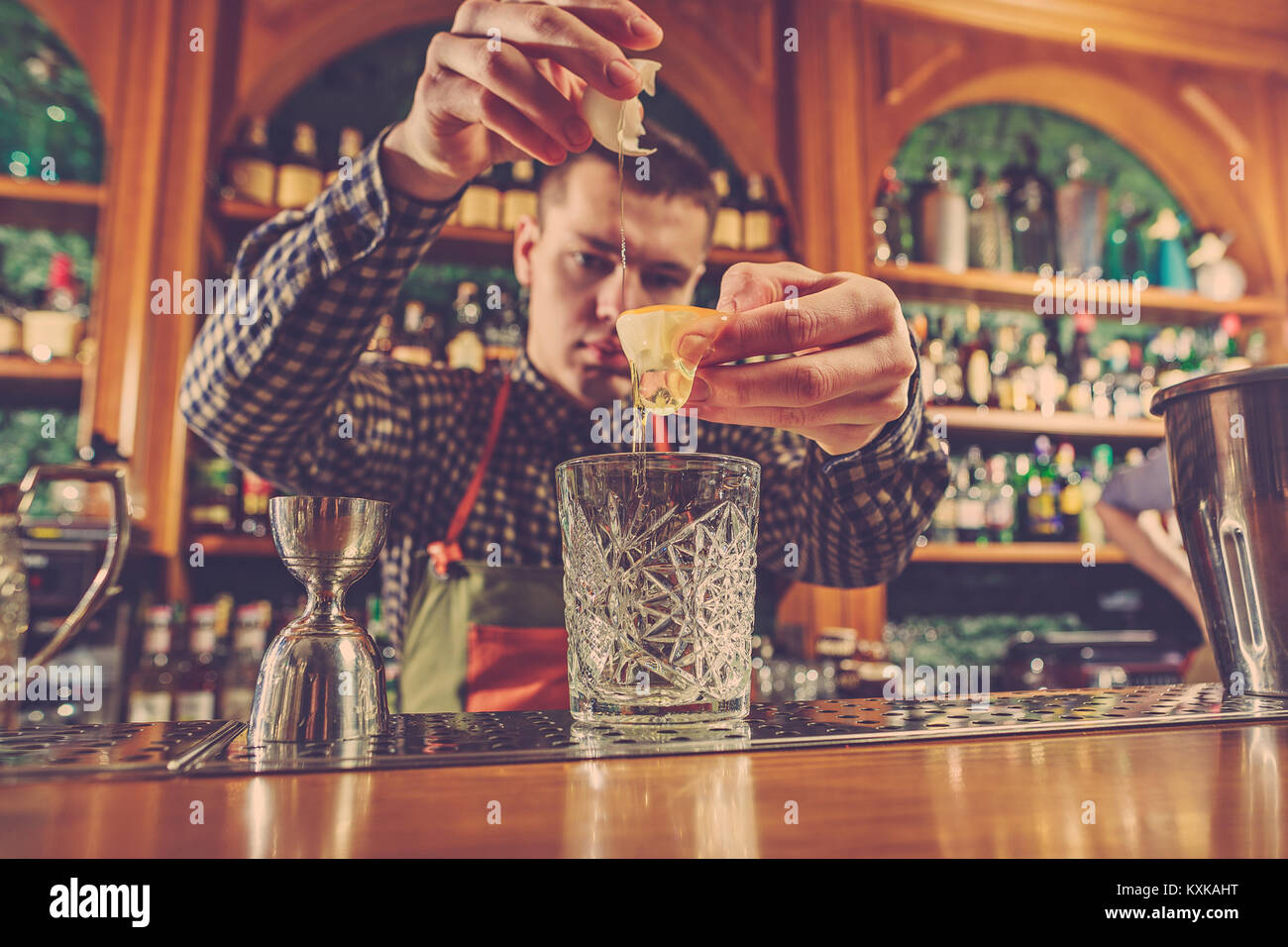 Barman making an alcoholic cocktail at the bar counter on the bar ...