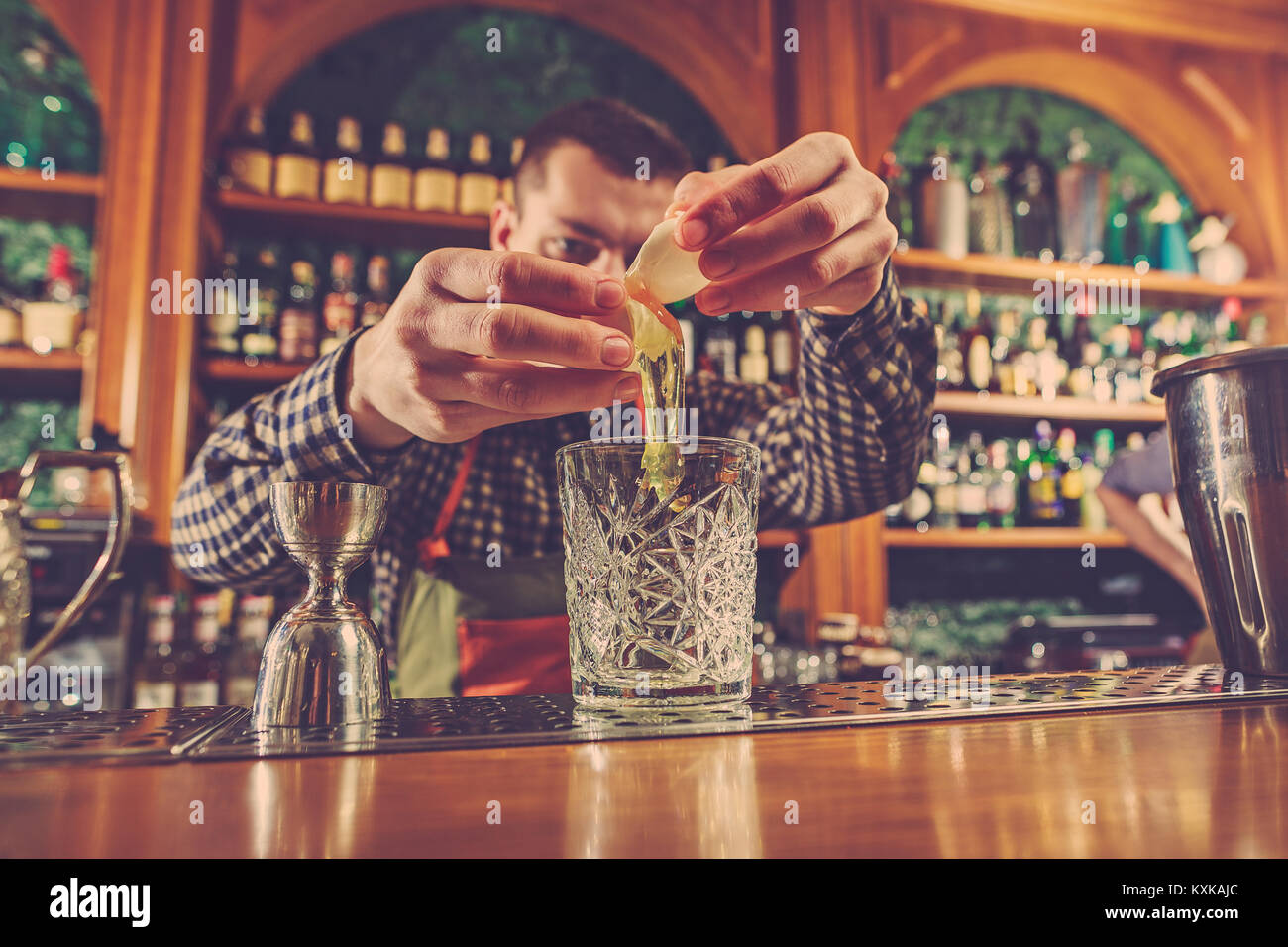 Barman making an alcoholic cocktail at the bar counter on the bar ...