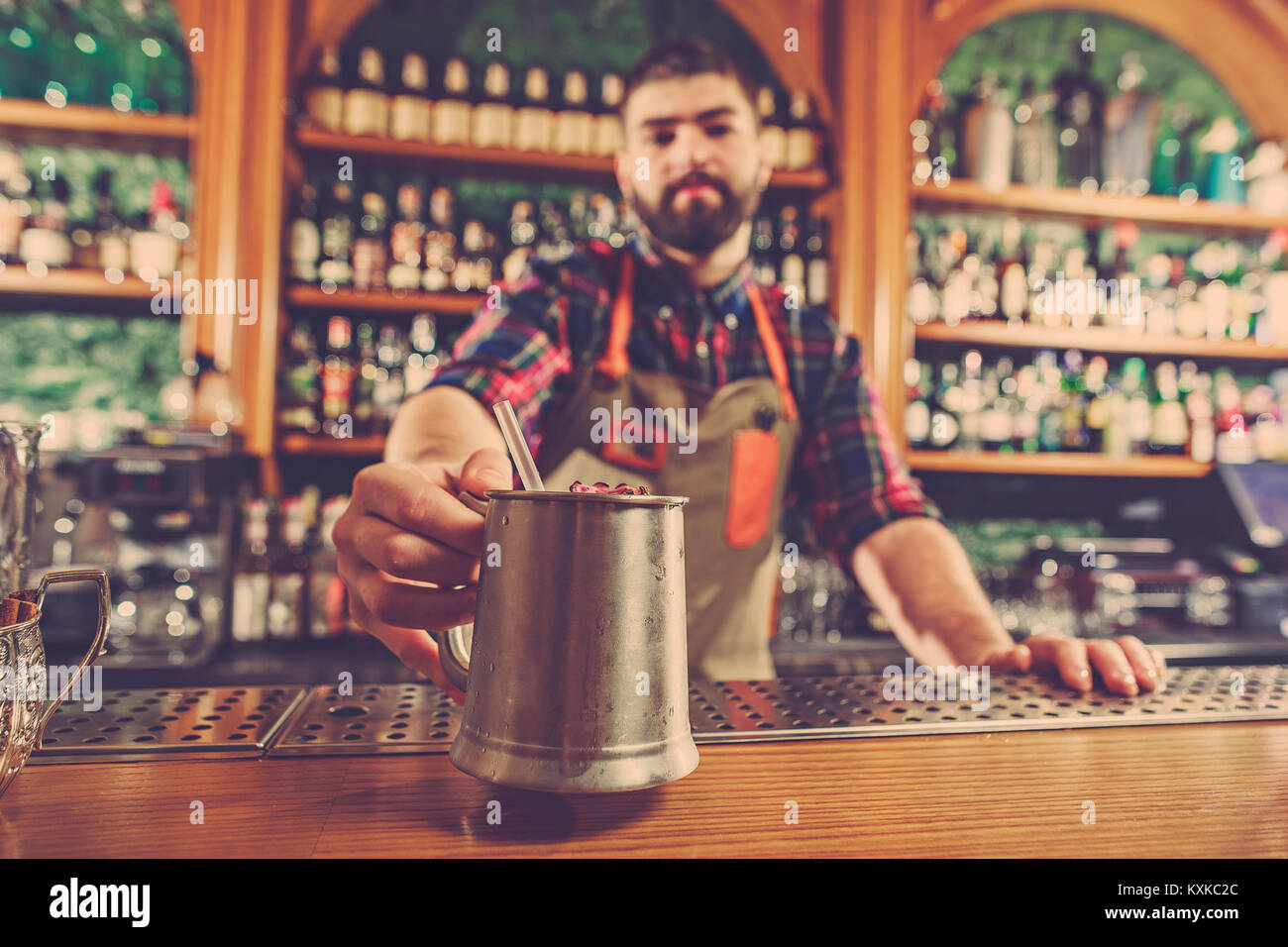 Barman making an alcoholic cocktail at the bar counter on the bar ...