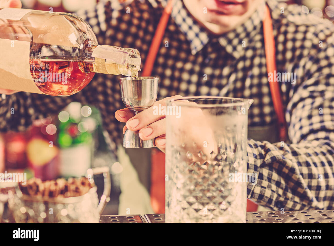 Barman making an alcoholic cocktail at the bar counter on the bar ...