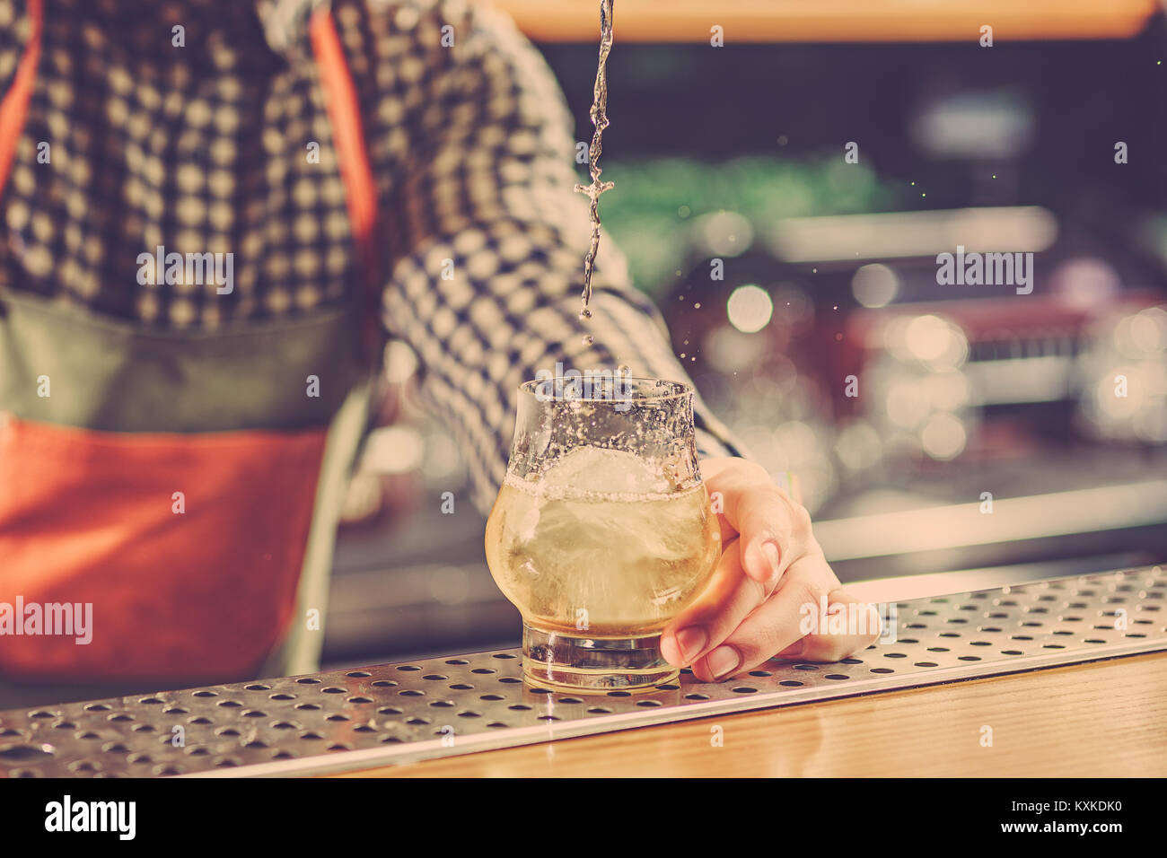 Barman making an alcoholic cocktail at the bar counter on the bar ...