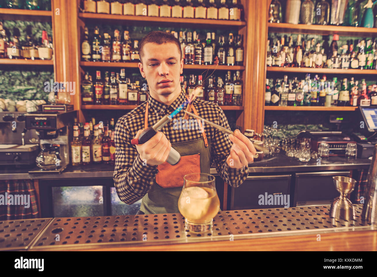 Barman making an alcoholic cocktail at the bar counter on the bar ...