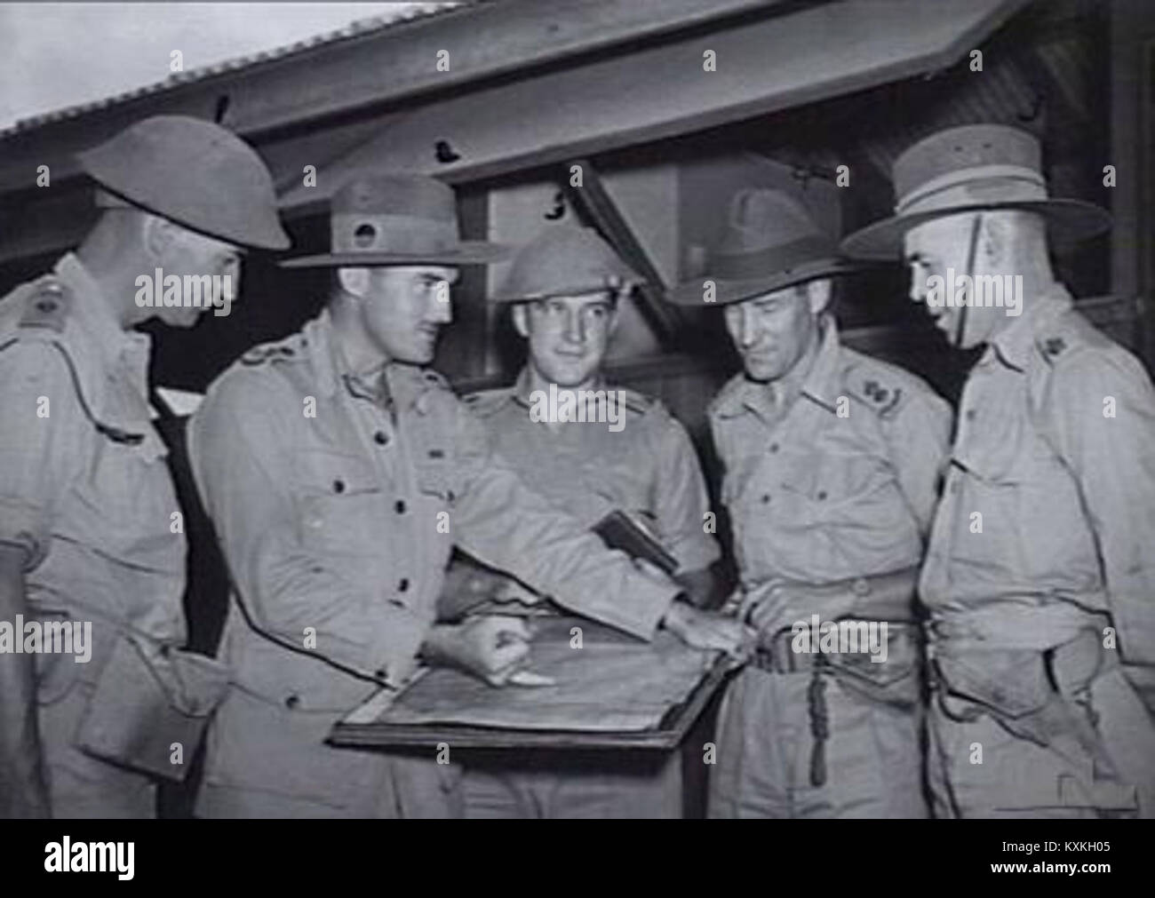 This historical image depicts officers of the Australian 30th Brigade ...