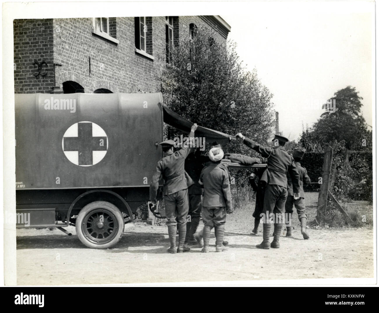 A wartime photograph depicting the arrival of a casualty at a ...