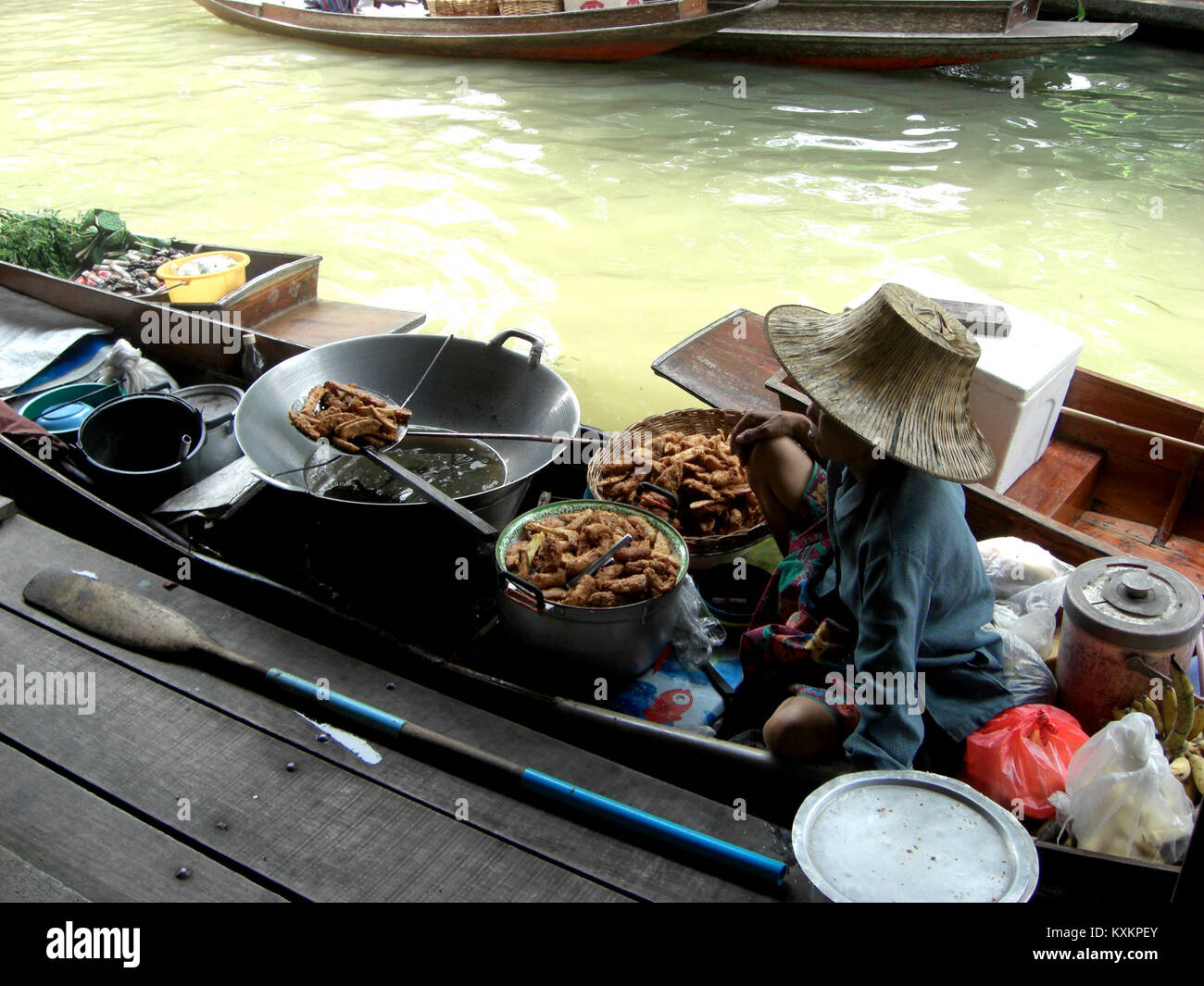 A historical image of a floating market boat, showcasing a traditional ...