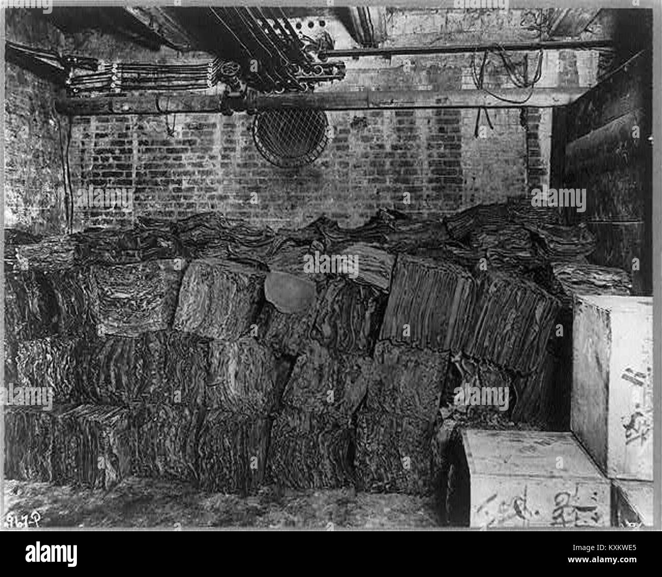 Bales of plantation rubber in Brazil are shown stacked and prepared for ...