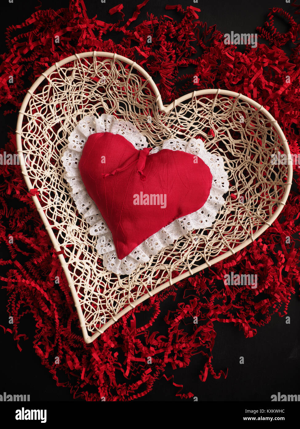 Red fabric heart shape on red shredded paper, love concepts Valentines ...