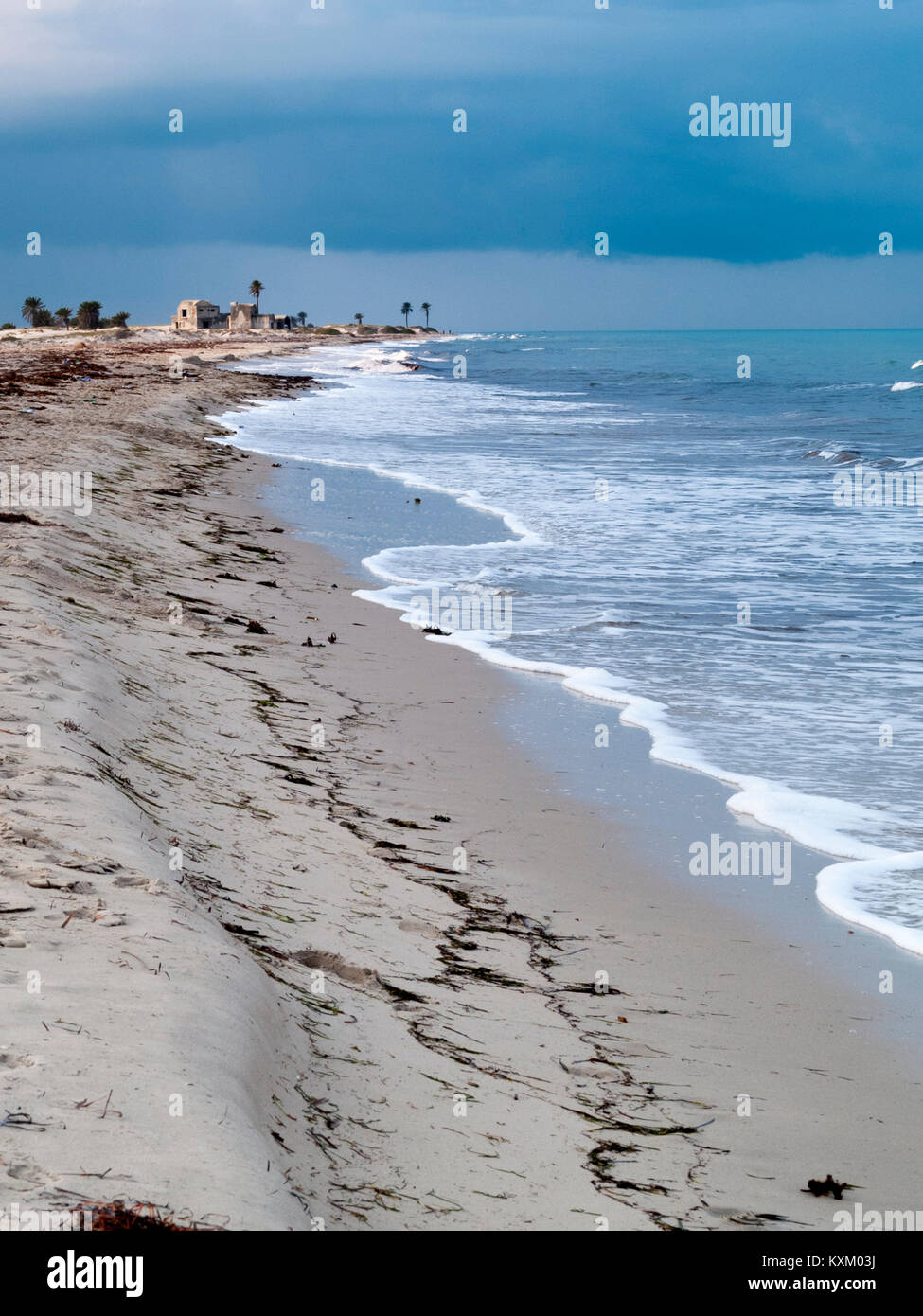 Djerba, Tunisia, beach with sea and waves, cloudy and threatening sky ...