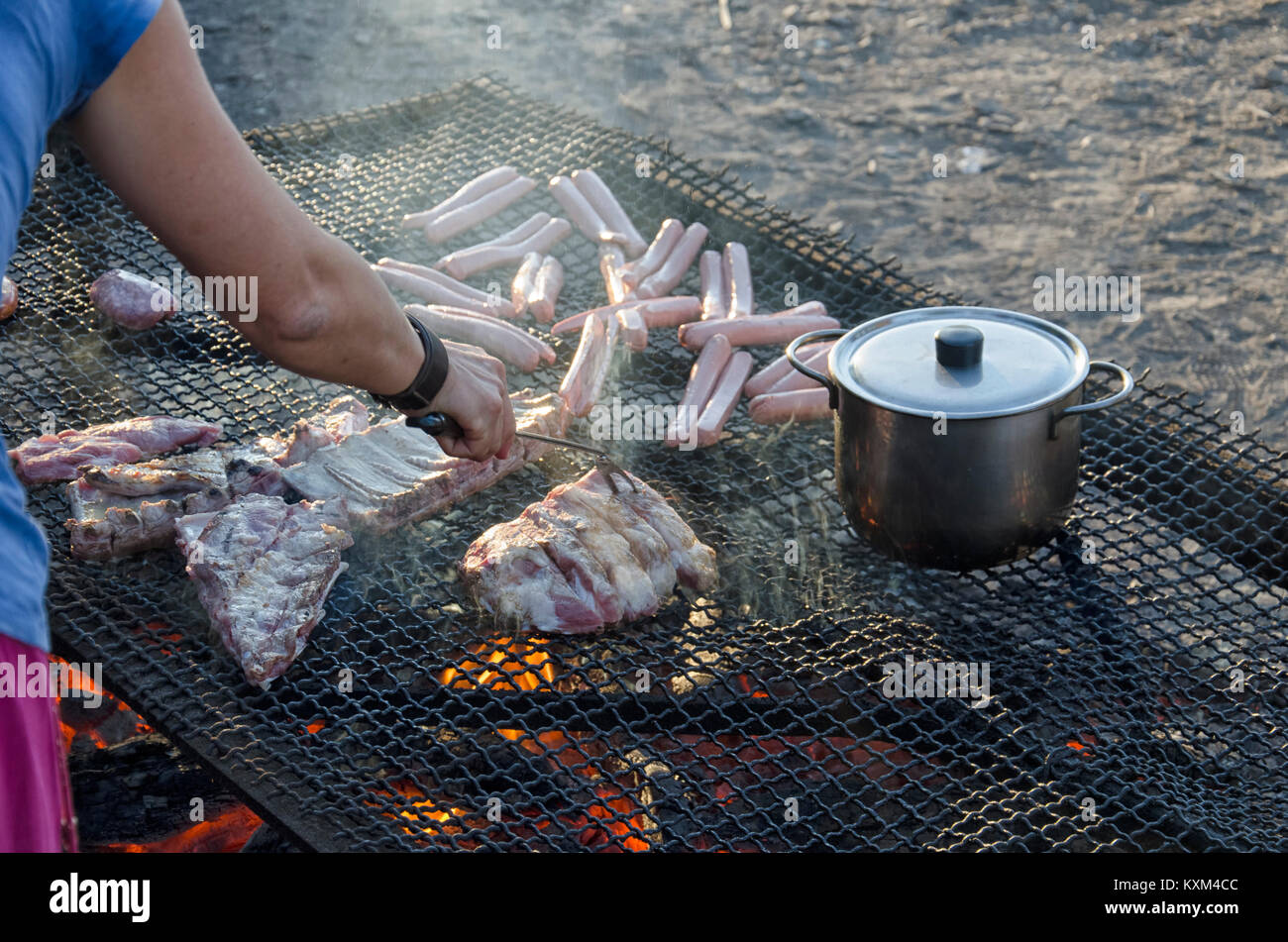 View of various types of meat baking on the grill Stock Photo - Alamy