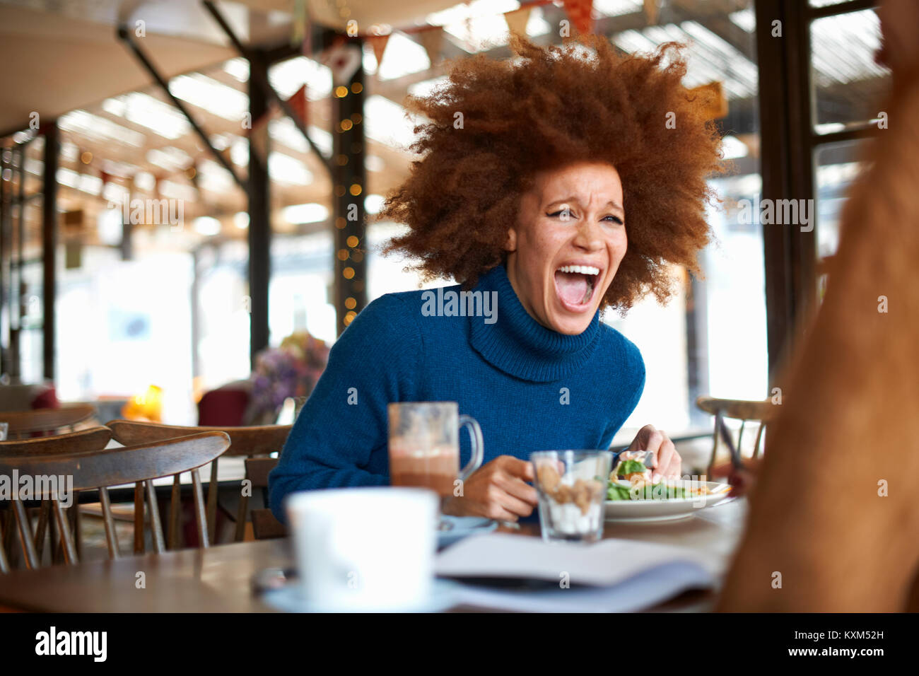 Woman laughing cafe hi-res stock photography and images - Alamy