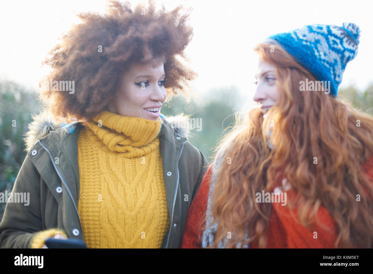 Friends face to face smiling Stock Photo - Alamy