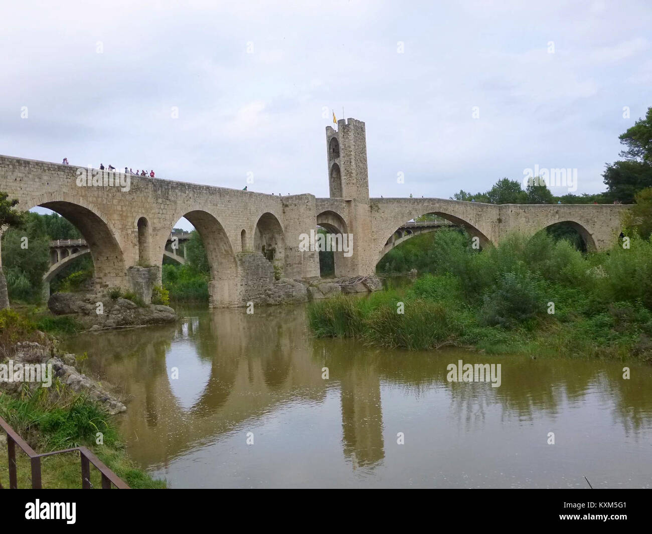 This image captures the Pont Vell, an iconic bridge in Besal, Spain ...
