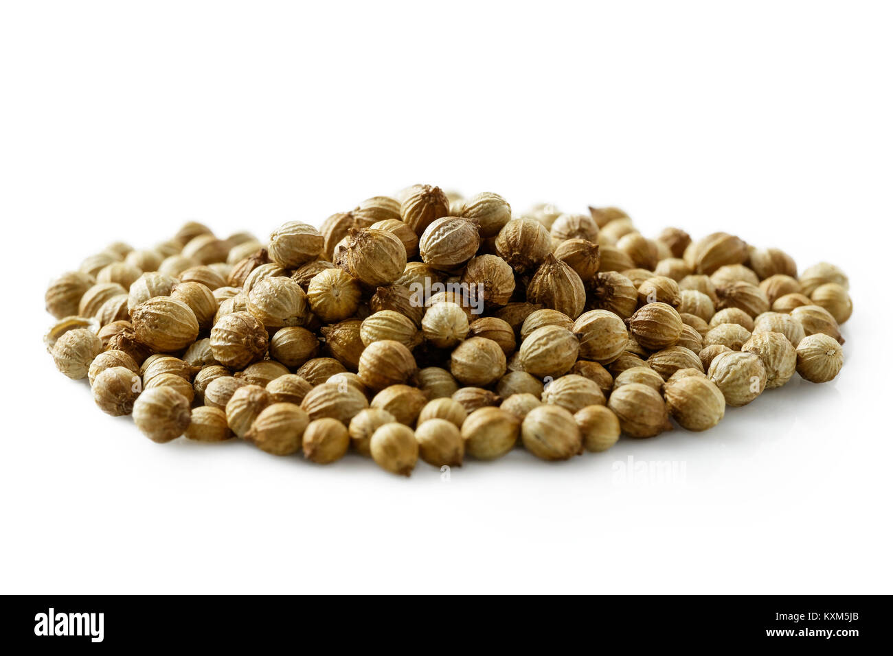 A pile of whole dried coriander seeds isolated on white Stock Photo - Alamy